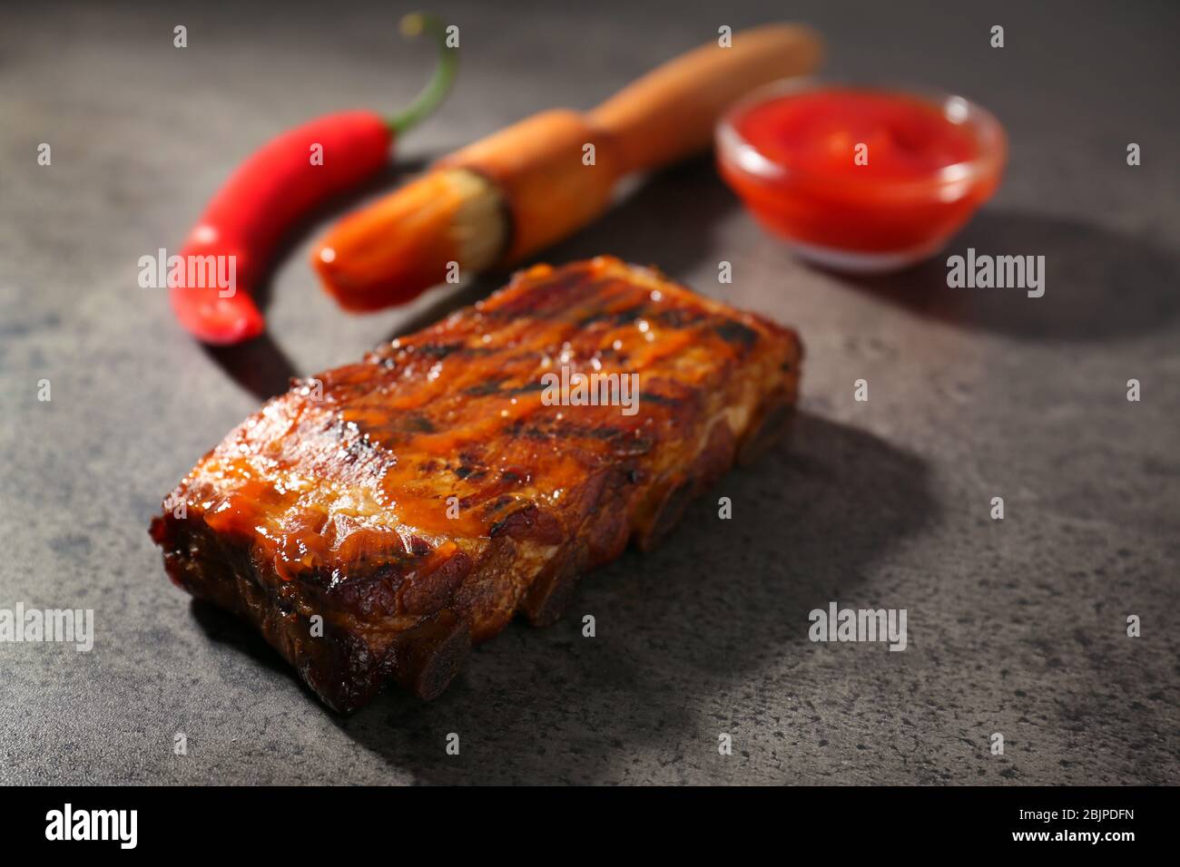 Delicious grilled ribs on table Stock Photo - Alamy