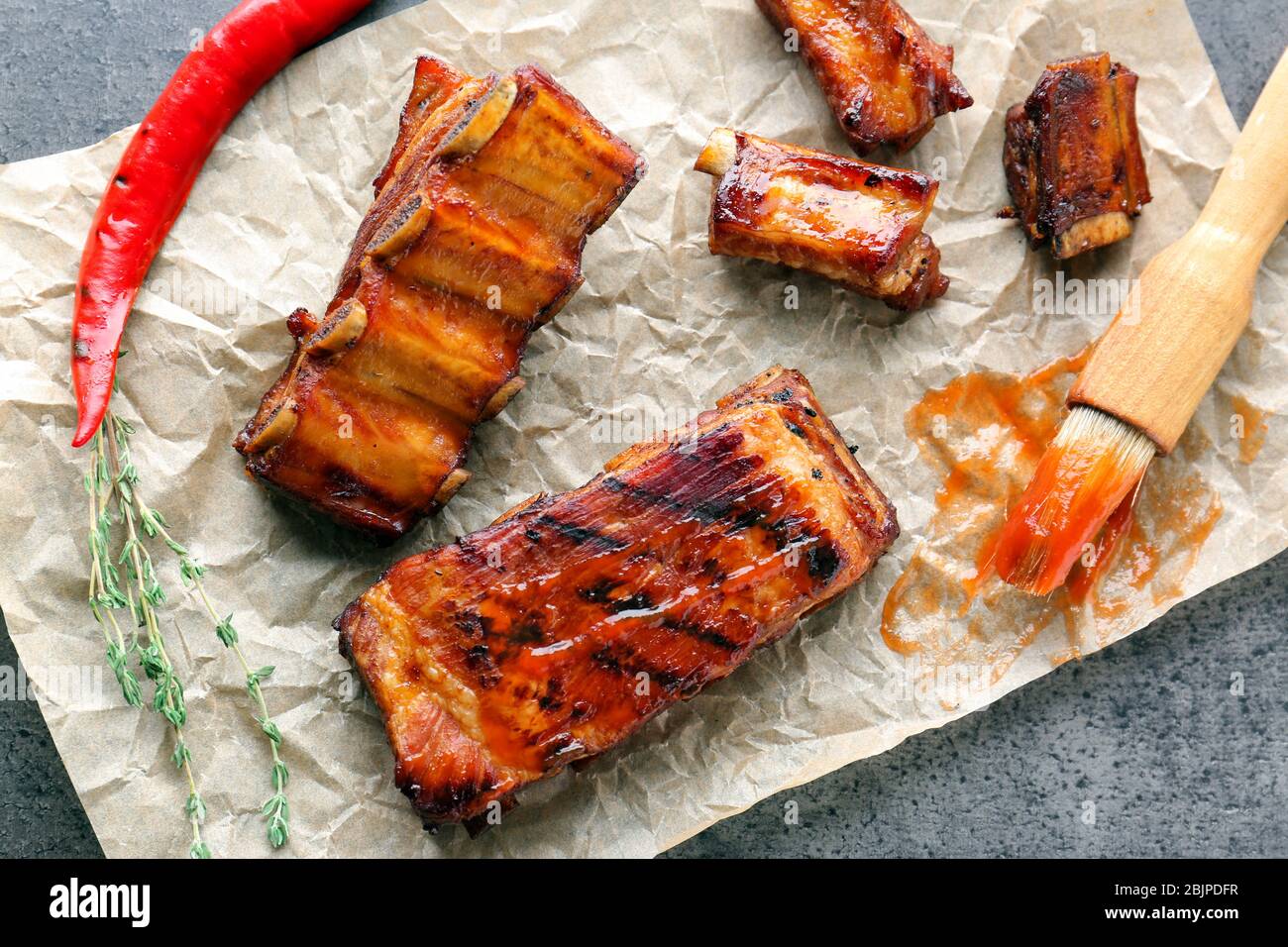 Delicious grilled ribs on table Stock Photo - Alamy