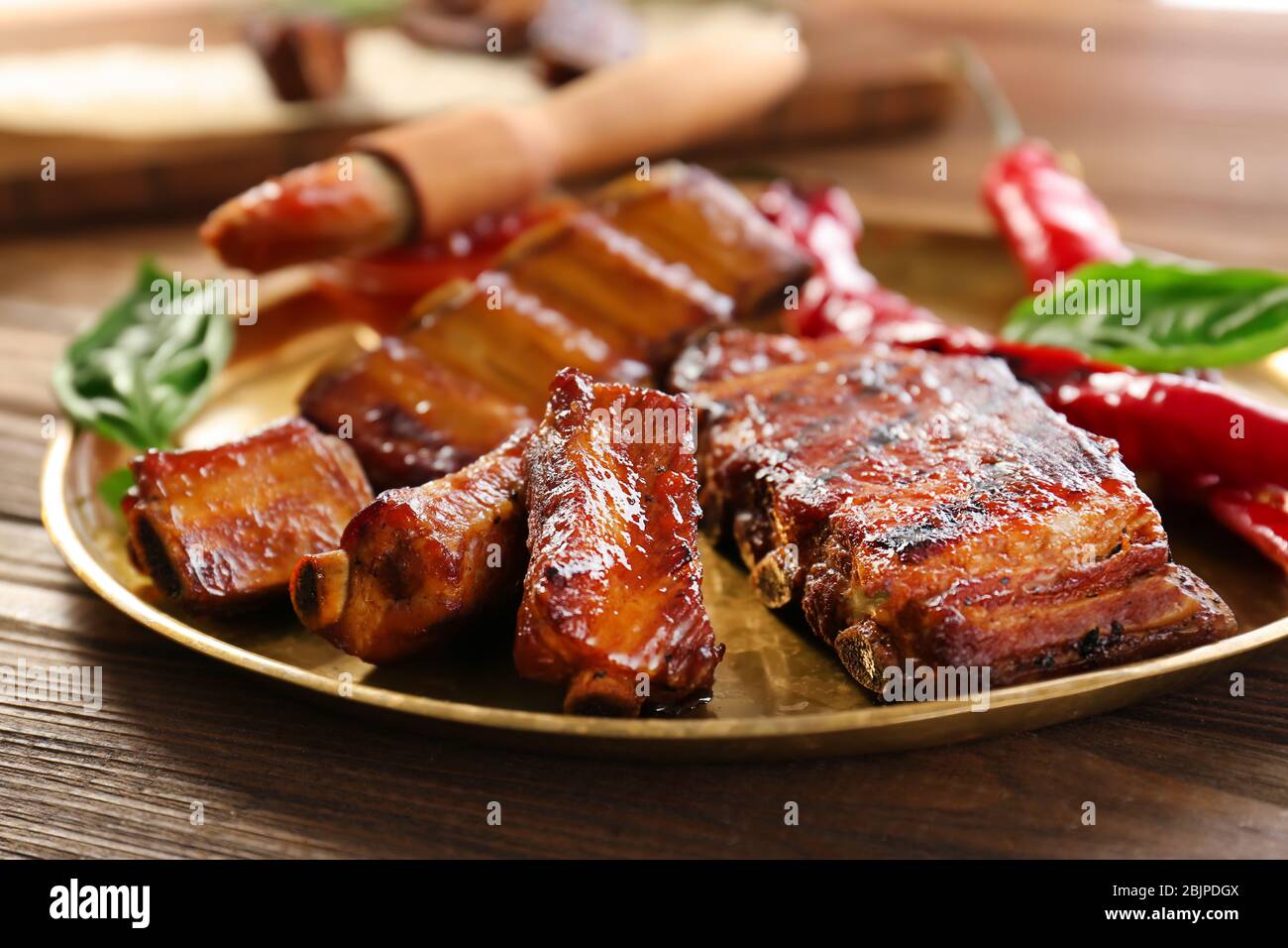 Plate with delicious grilled ribs on table Stock Photo - Alamy