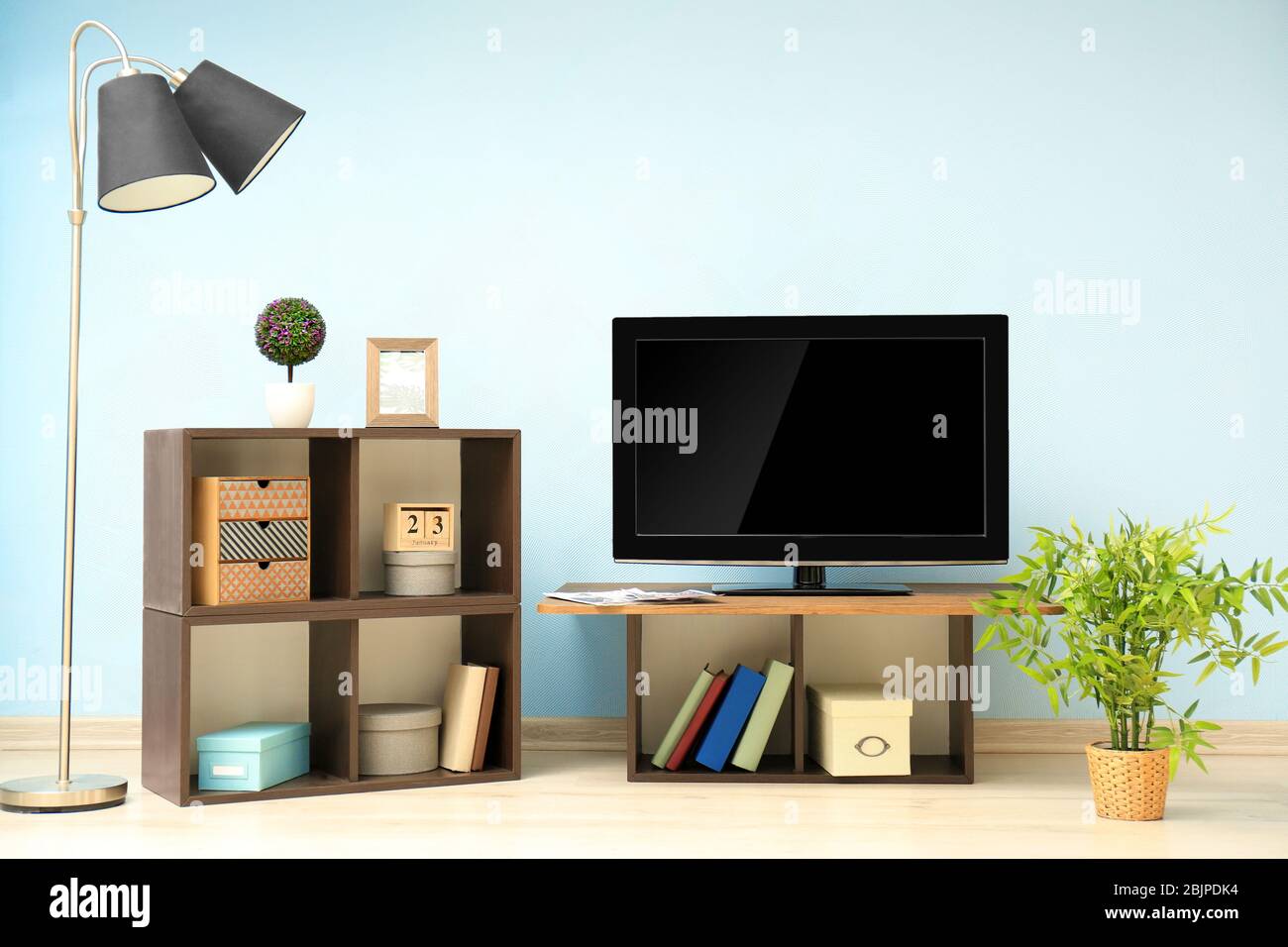 Modern TV set on stand in living room Stock Photo - Alamy