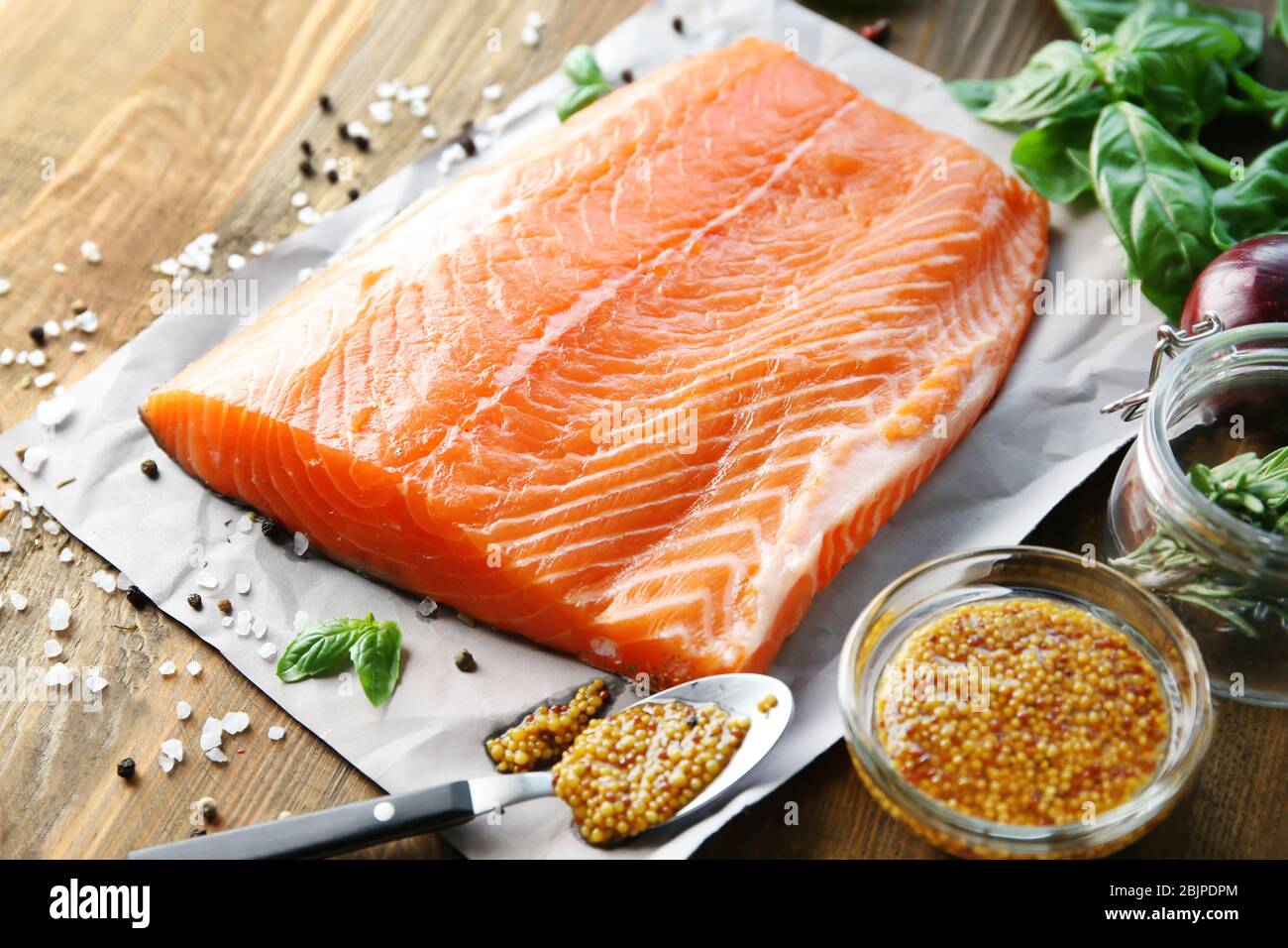 Fresh raw salmon fillet with honey mustard marinade on wooden table ...
