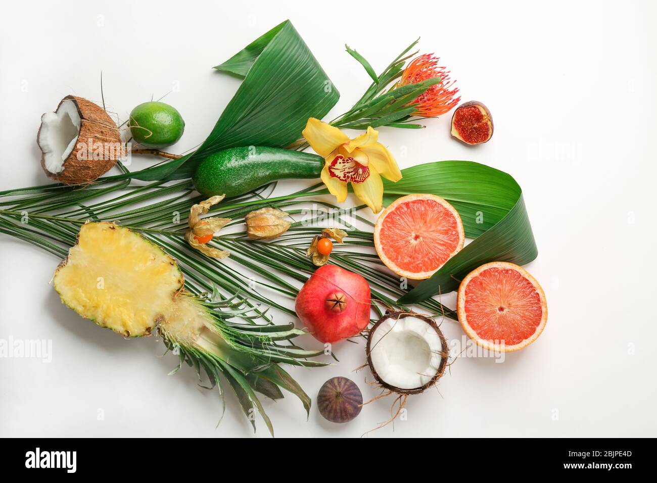 Composition with tropical leaves and exotic fruits on light background ...