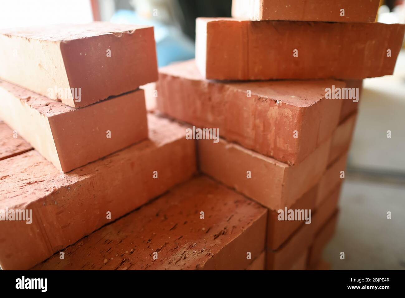 Building materials are on floor, stack red bricks Stock Photo - Alamy