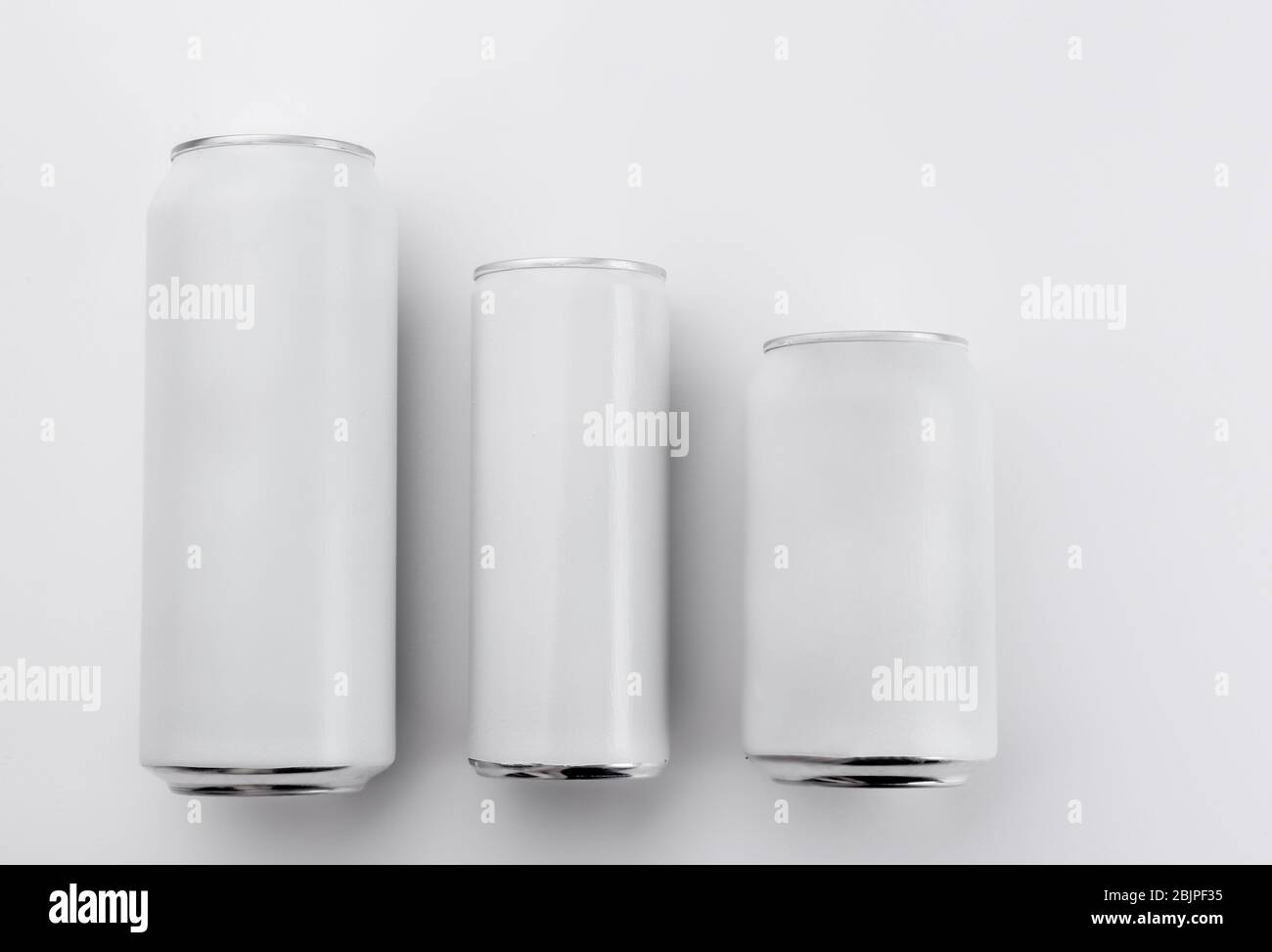 Three tin cans, isolated on white Stock Photo - Alamy