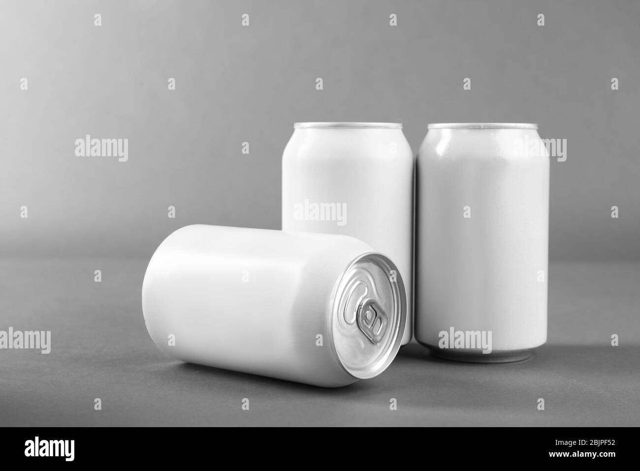 Tin cans on grey background Stock Photo - Alamy