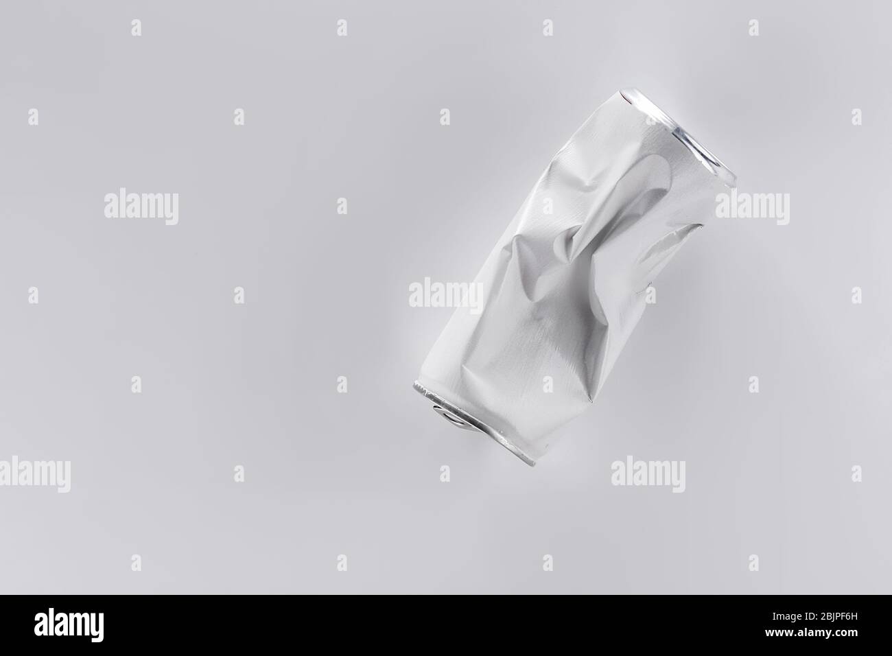 Crumpled empty can, isolated on white Stock Photo - Alamy