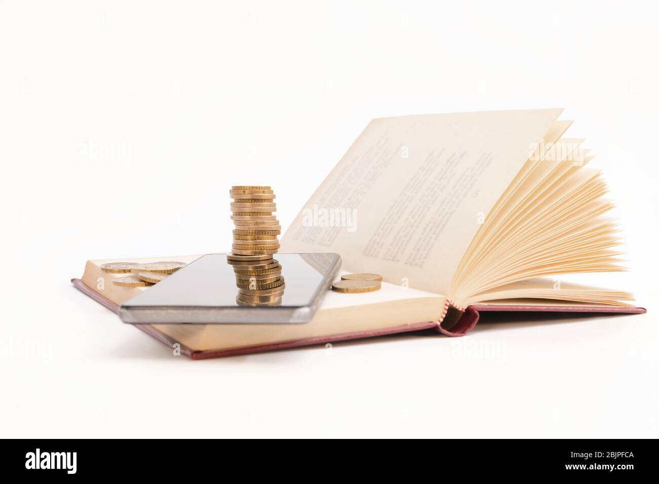 open book with phone and stack coins Stock Photo - Alamy