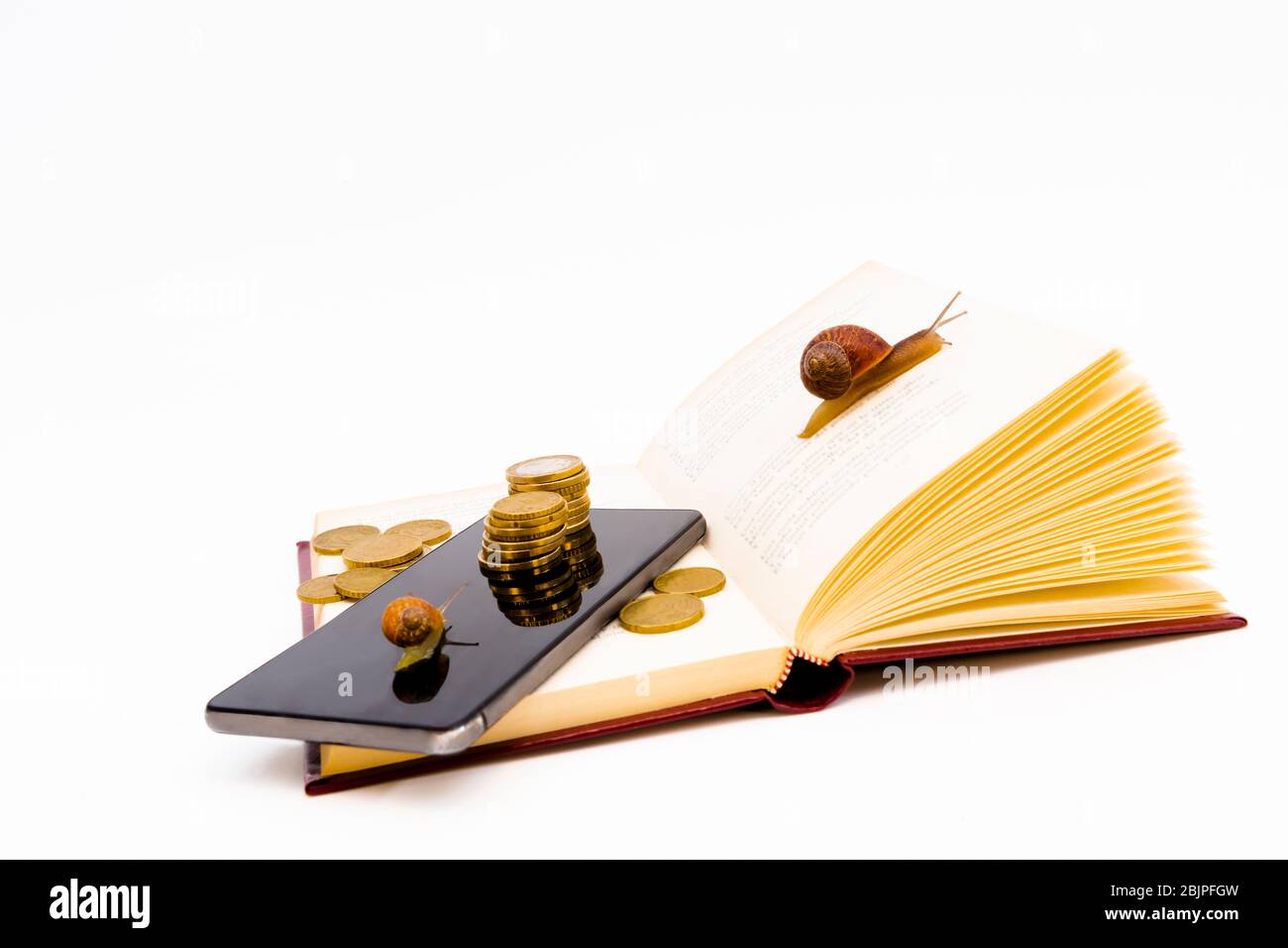 open book with phone and stack coins and snail Stock Photo - Alamy