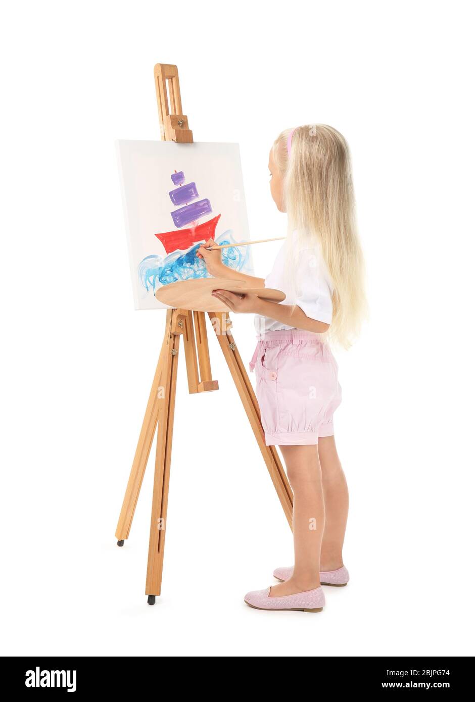 Cute little girl painting picture on canvas against white background ...