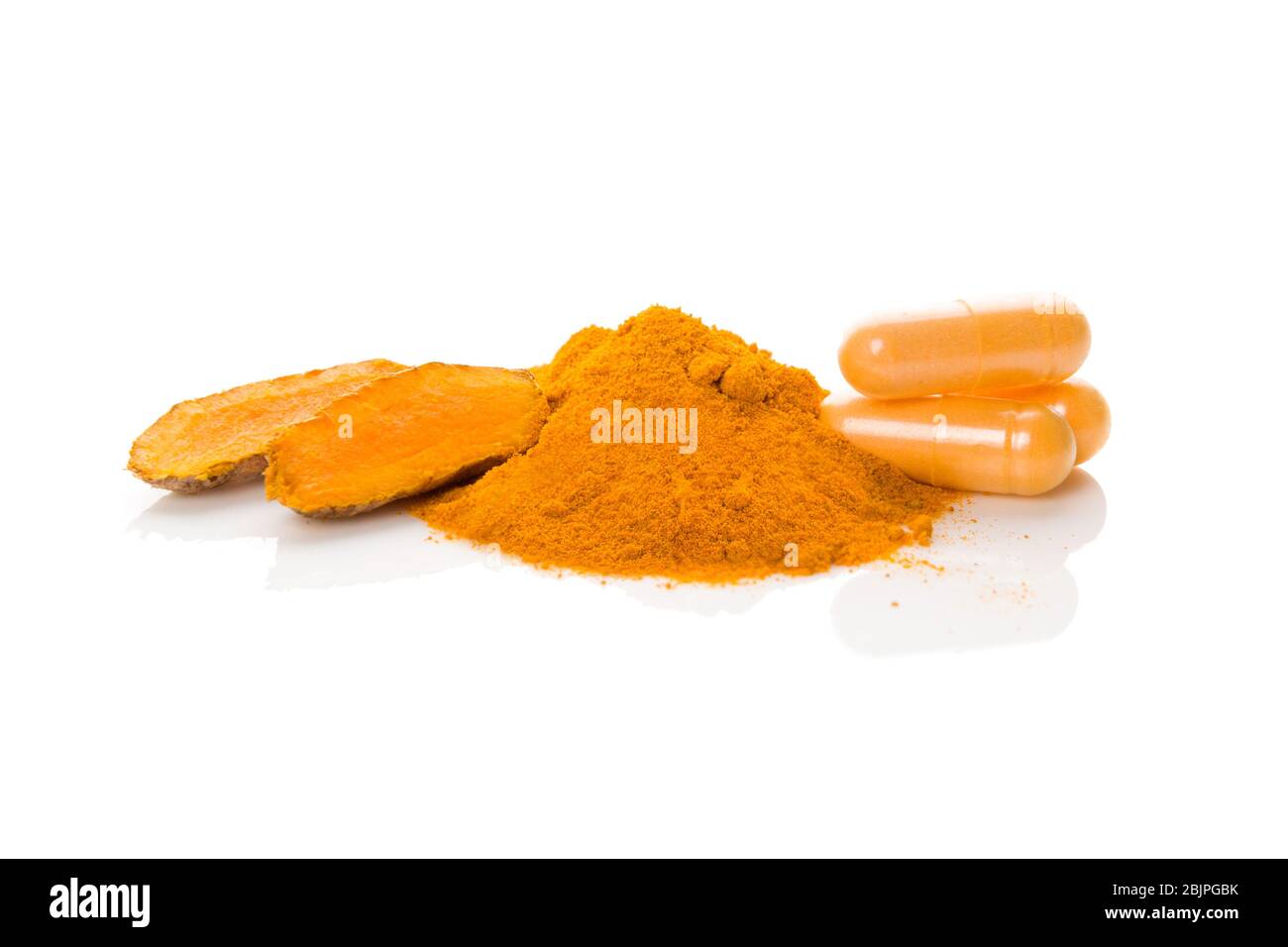 Curcumin root, turmeric powder and gel capsules on white background ...