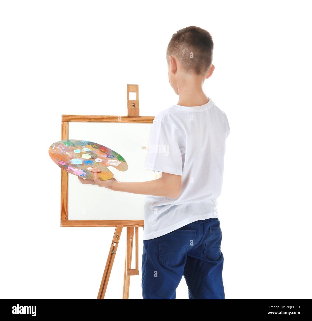 Cute little boy painting picture on canvas against white background ...