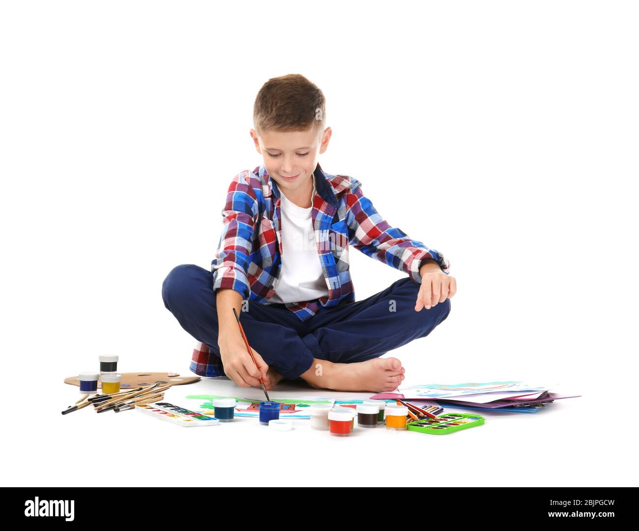 Cute little boy painting against white background Stock Photo - Alamy