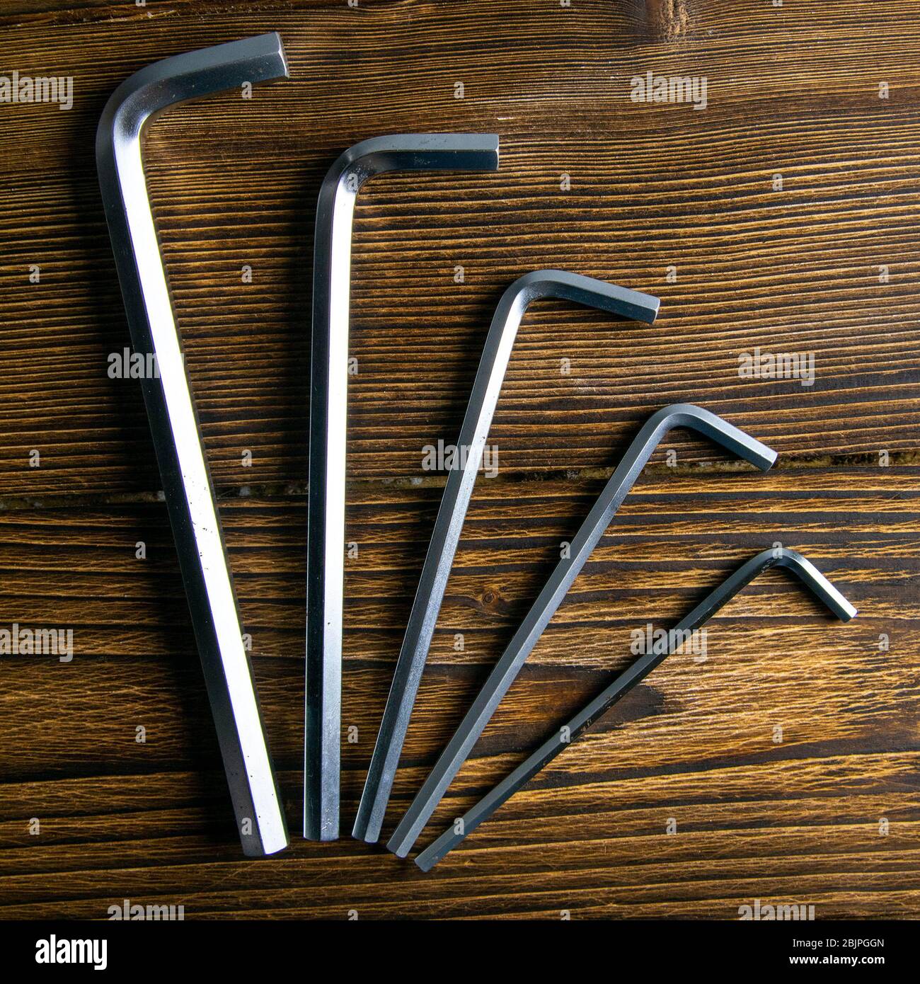 Set of hexagonal keys on a wooden table. Top view Stock Photo - Alamy