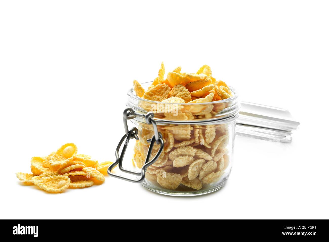 Glass jar with corn flakes on white background Stock Photo - Alamy