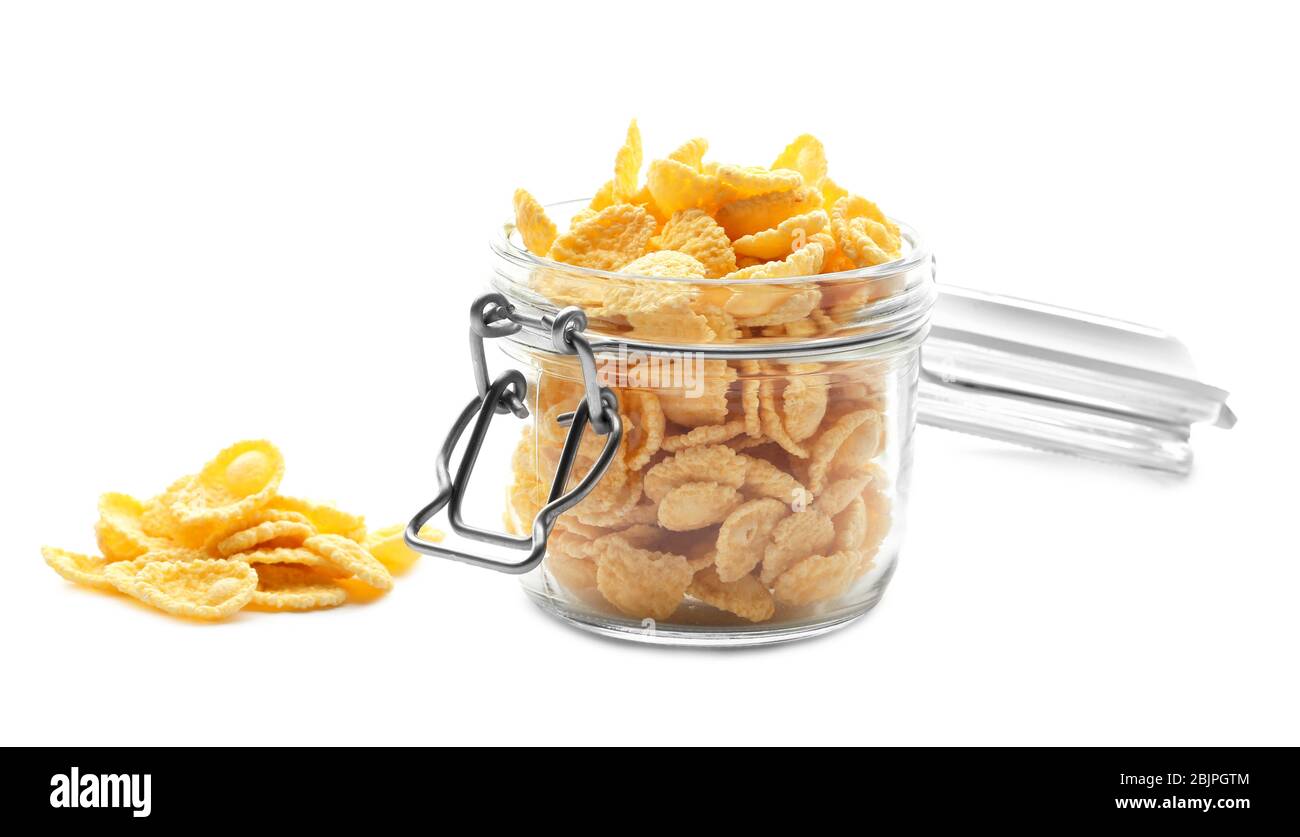 Glass jar with corn flakes on white background Stock Photo - Alamy