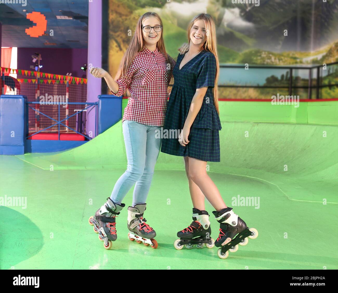 Charming teenage girls at roller skating rink Stock Photo - Alamy