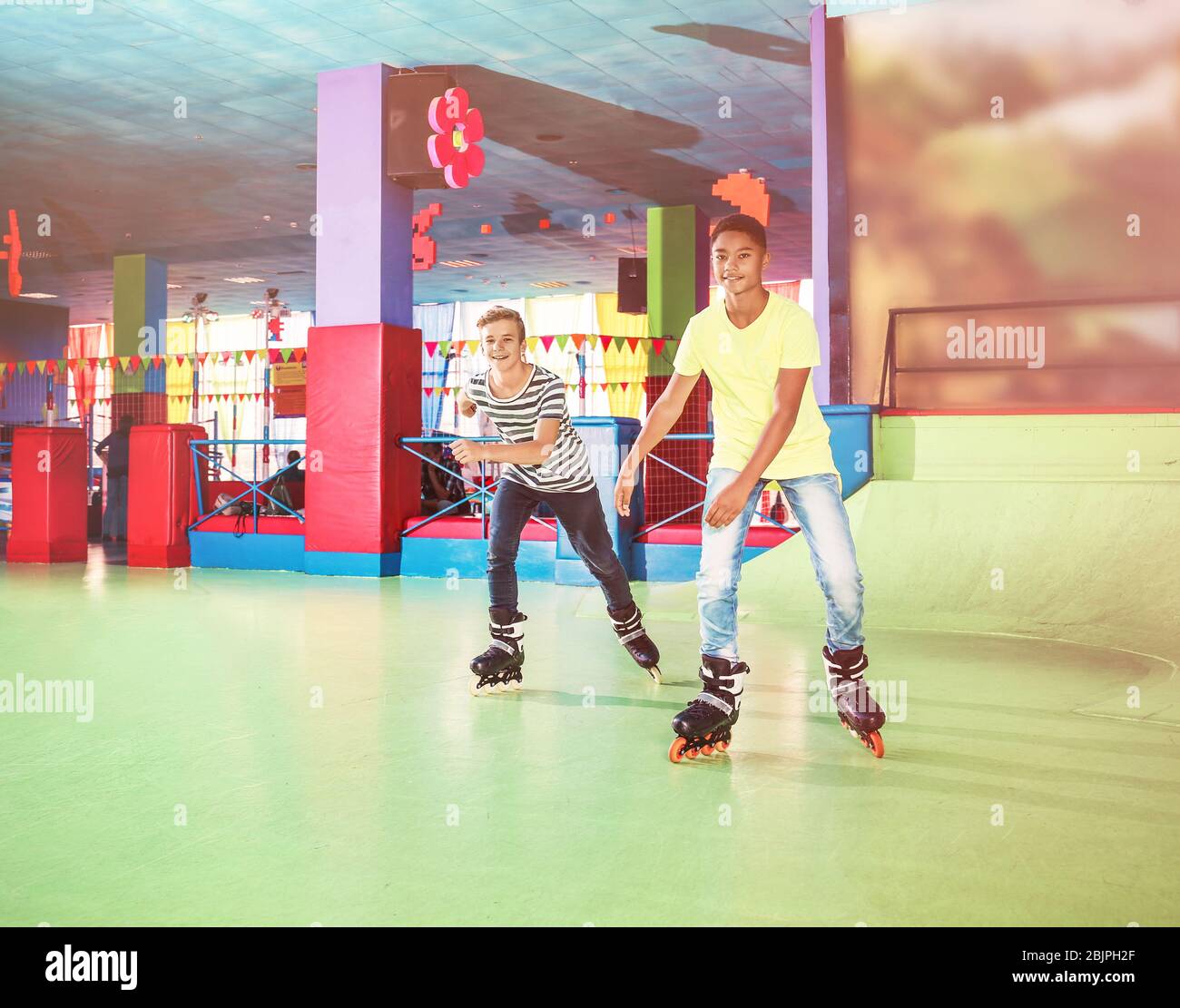 Teenage boys at roller skating rink Stock Photo - Alamy
