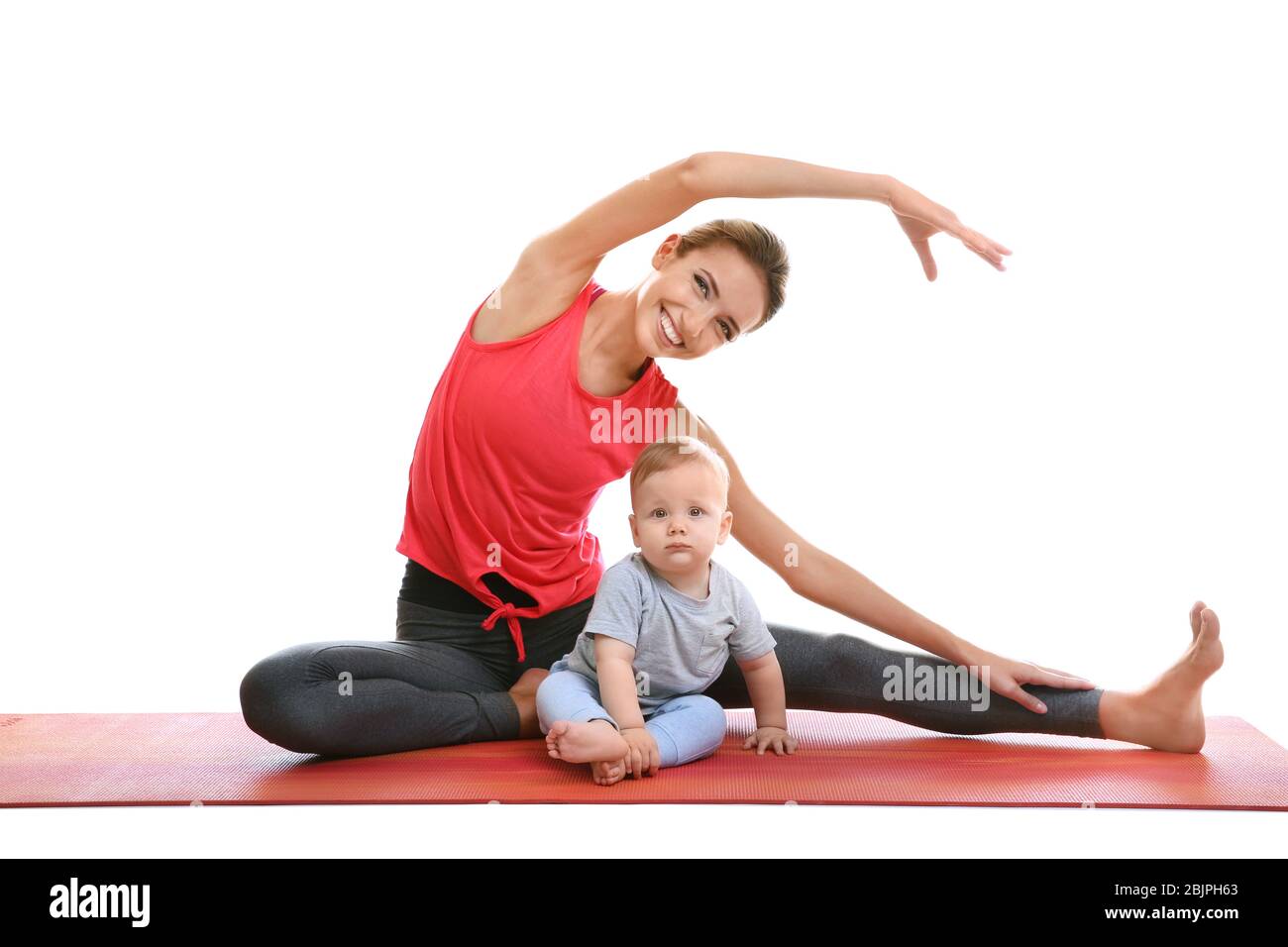 Young mother doing yoga with baby, isolated on white Stock Photo - Alamy