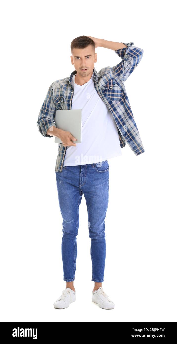 Confused young man with laptop on white background Stock Photo - Alamy