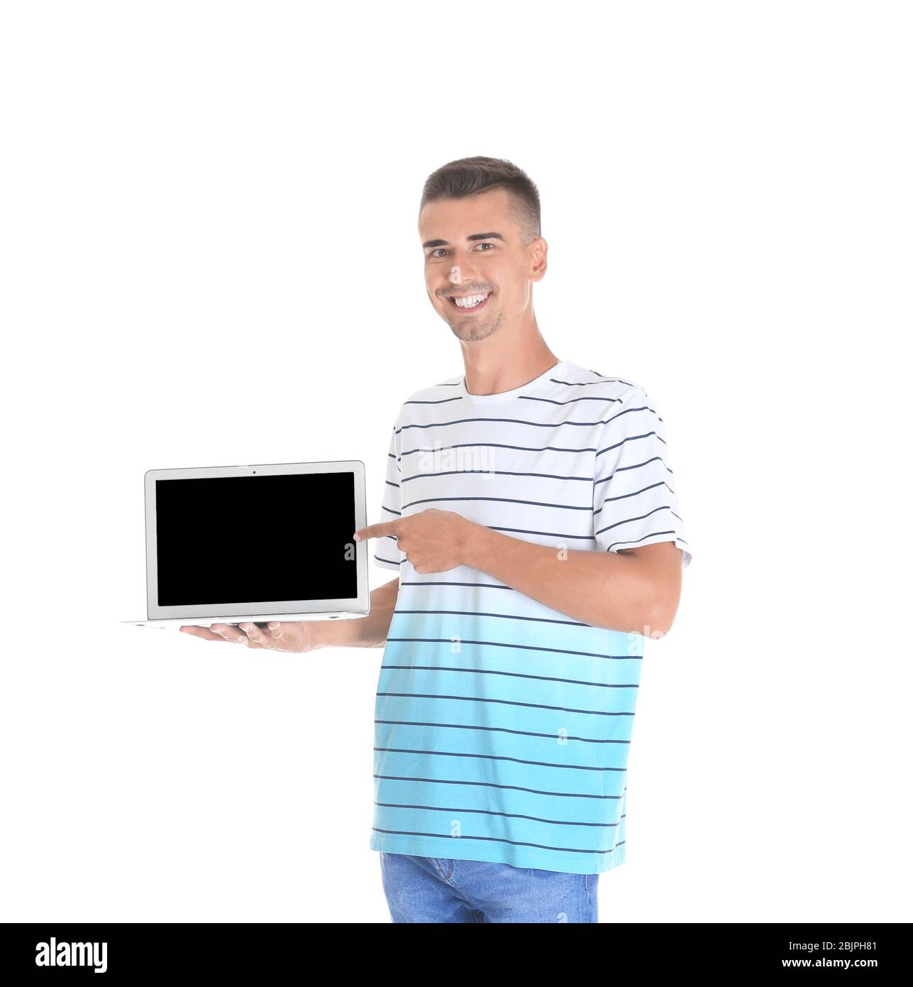Young man pointing at laptop screen against white background Stock ...