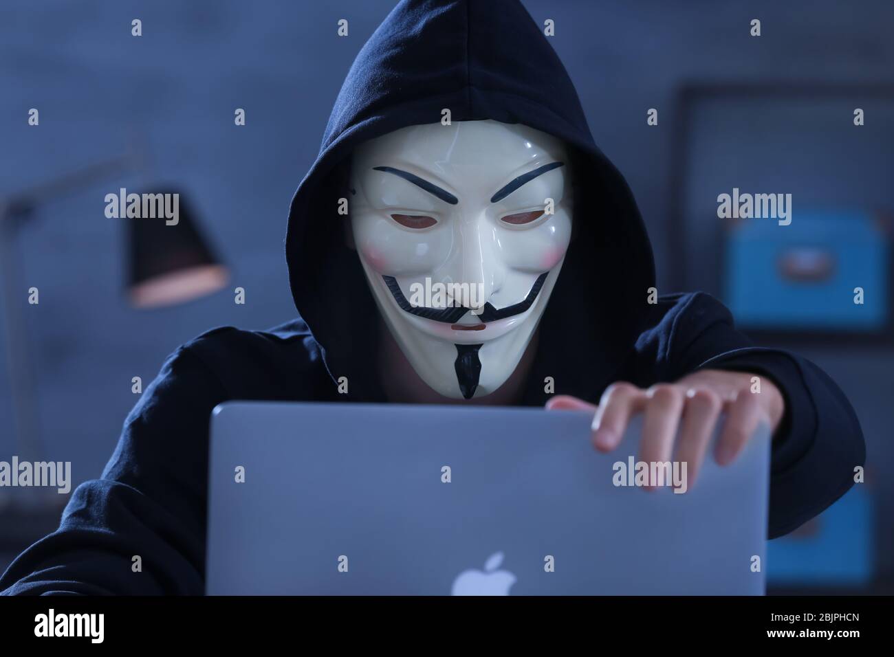 Hacker anonymous mask using laptop hi-res stock photography and images ...