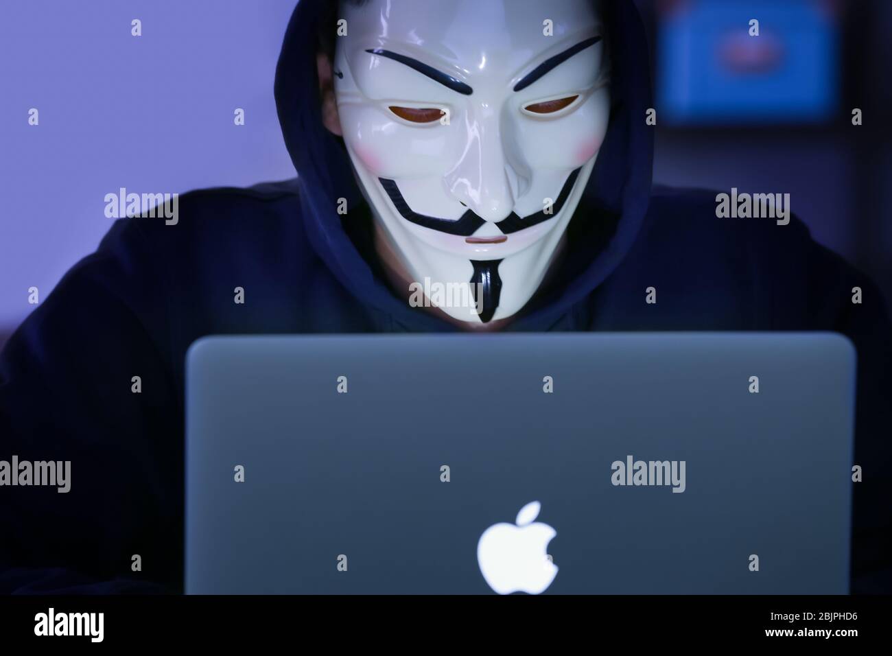 Hacker anonymous mask using laptop hi-res stock photography and images ...