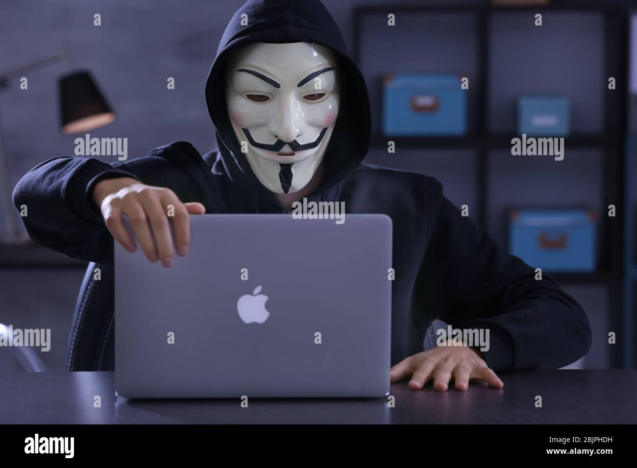Hacker anonymous mask using laptop hi-res stock photography and images ...