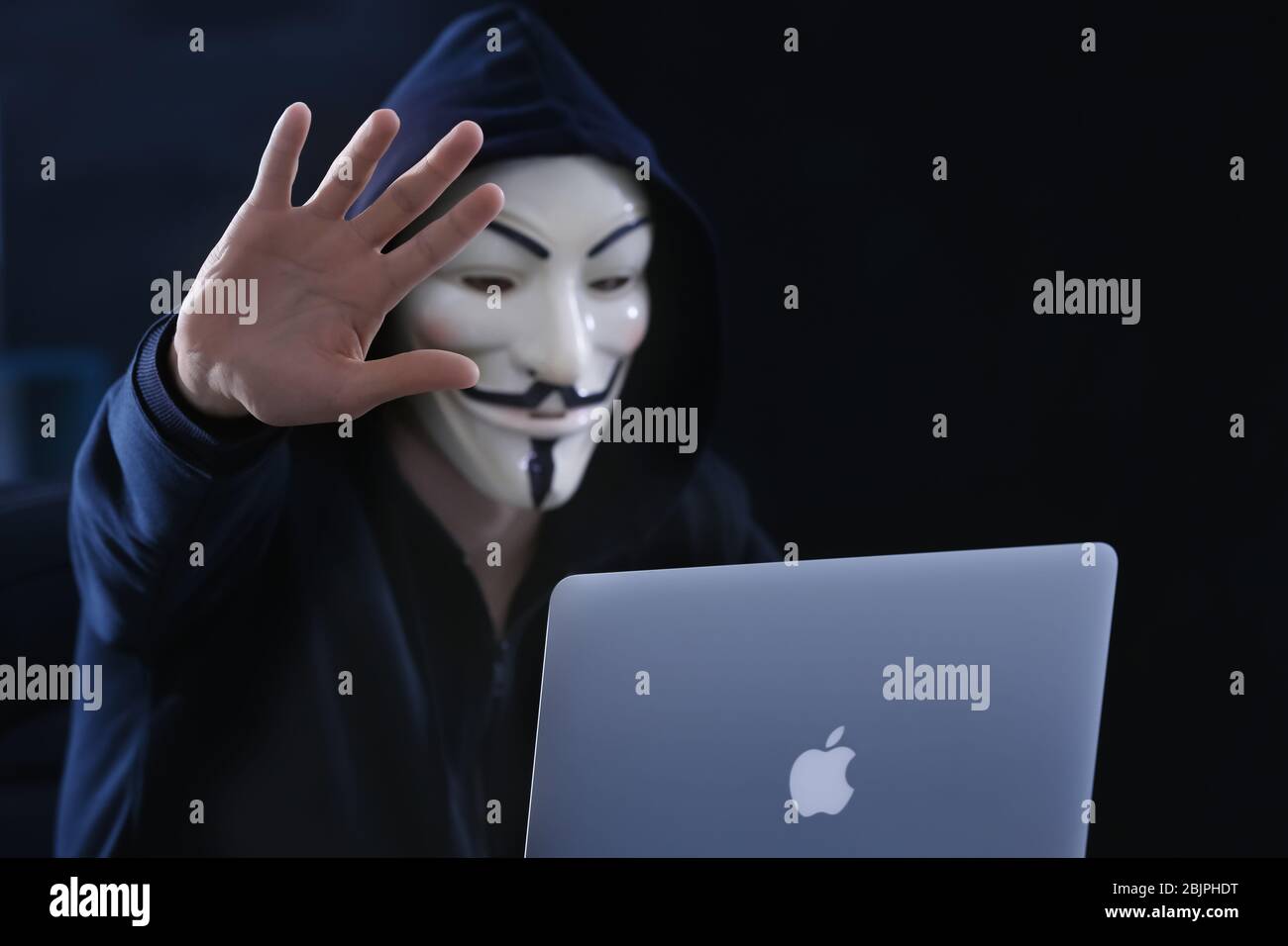 Hacker anonymous mask using laptop hi-res stock photography and images ...