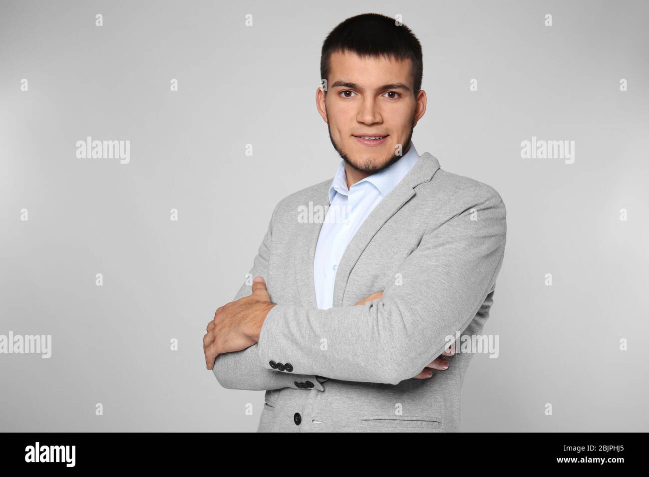 Male manager on grey background Stock Photo - Alamy