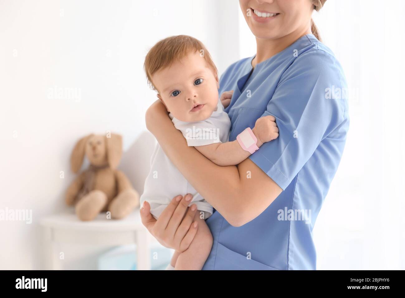 Female doctor with baby at hospital Stock Photo - Alamy