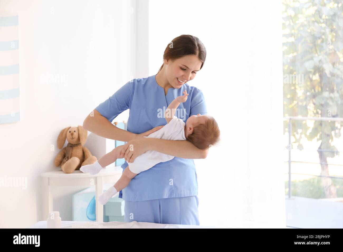 Female doctor with baby at hospital Stock Photo - Alamy