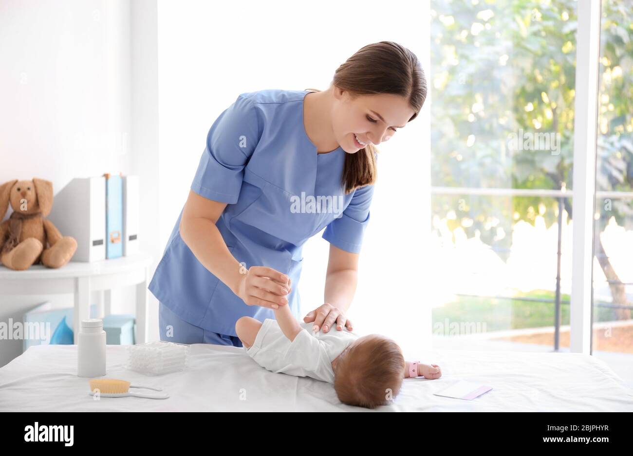 Female doctor with baby at hospital Stock Photo - Alamy
