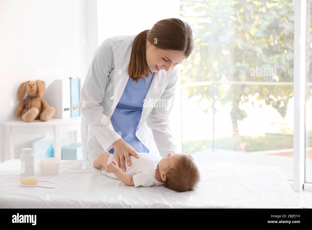 Female doctor with baby at hospital Stock Photo - Alamy