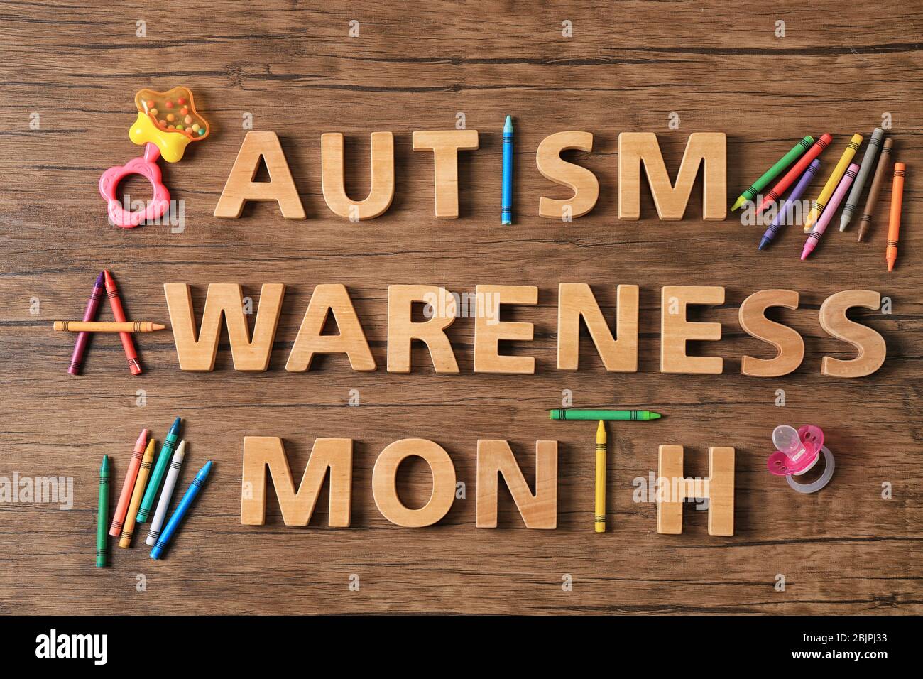 Text AUTISM AWARENESS MONTH on wooden background Stock Photo - Alamy