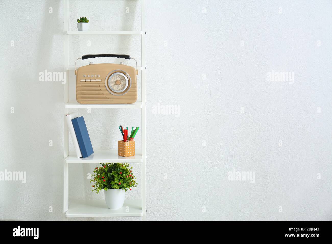 Retro radio on shelving in room Stock Photo - Alamy