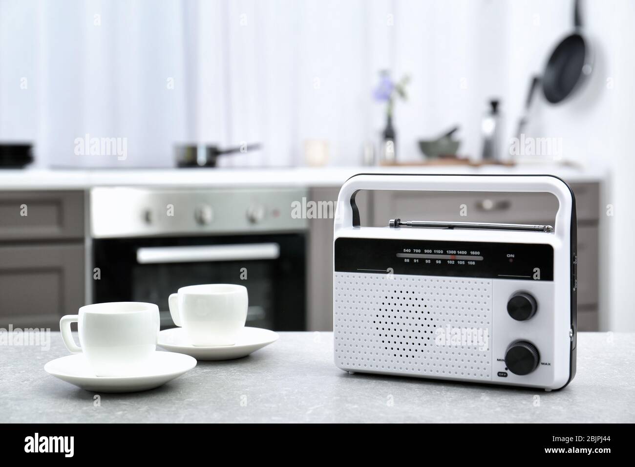 Retro radio on table in kitchen Stock Photo - Alamy