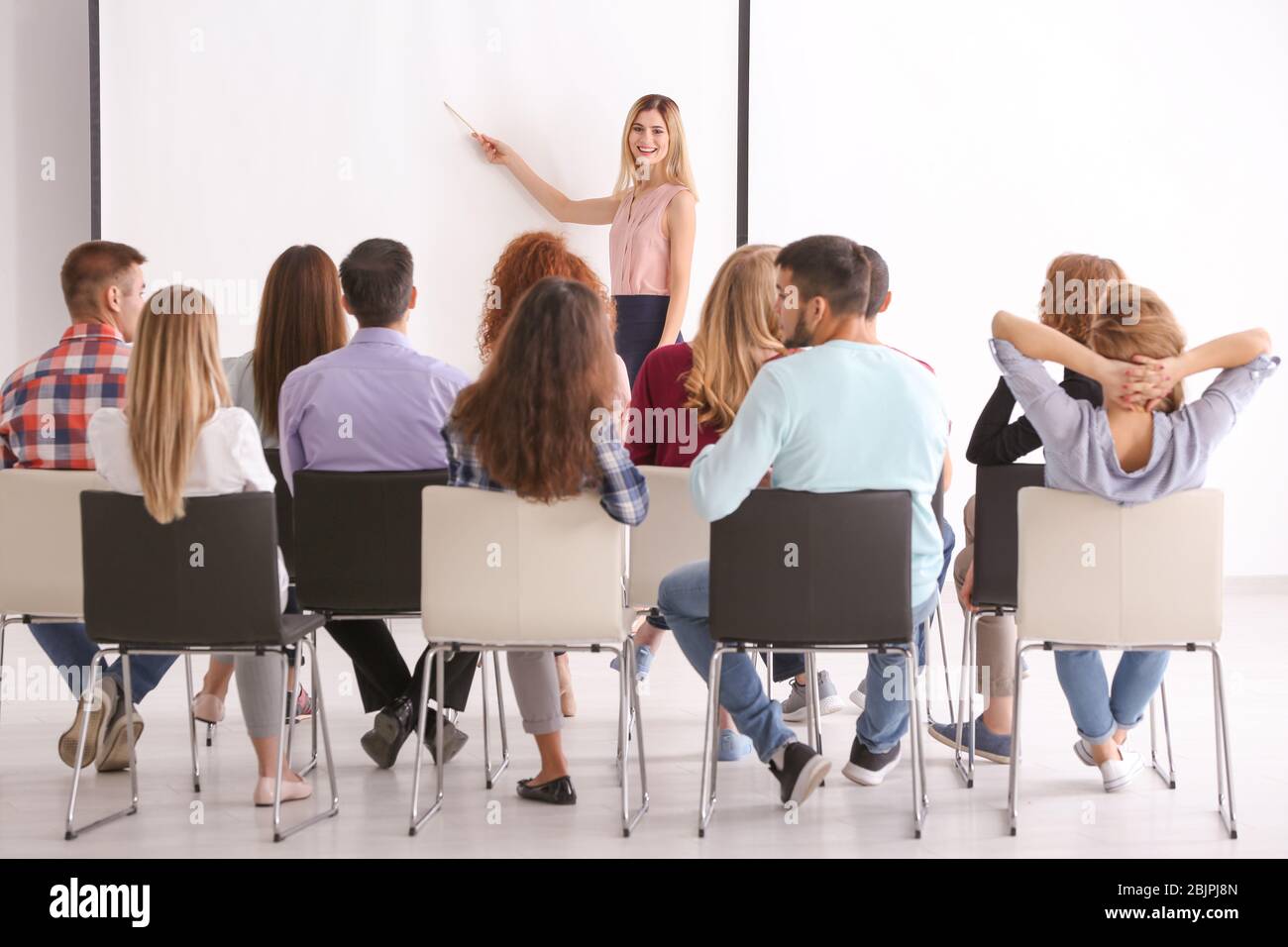 Group of people with business trainer at seminar Stock Photo - Alamy