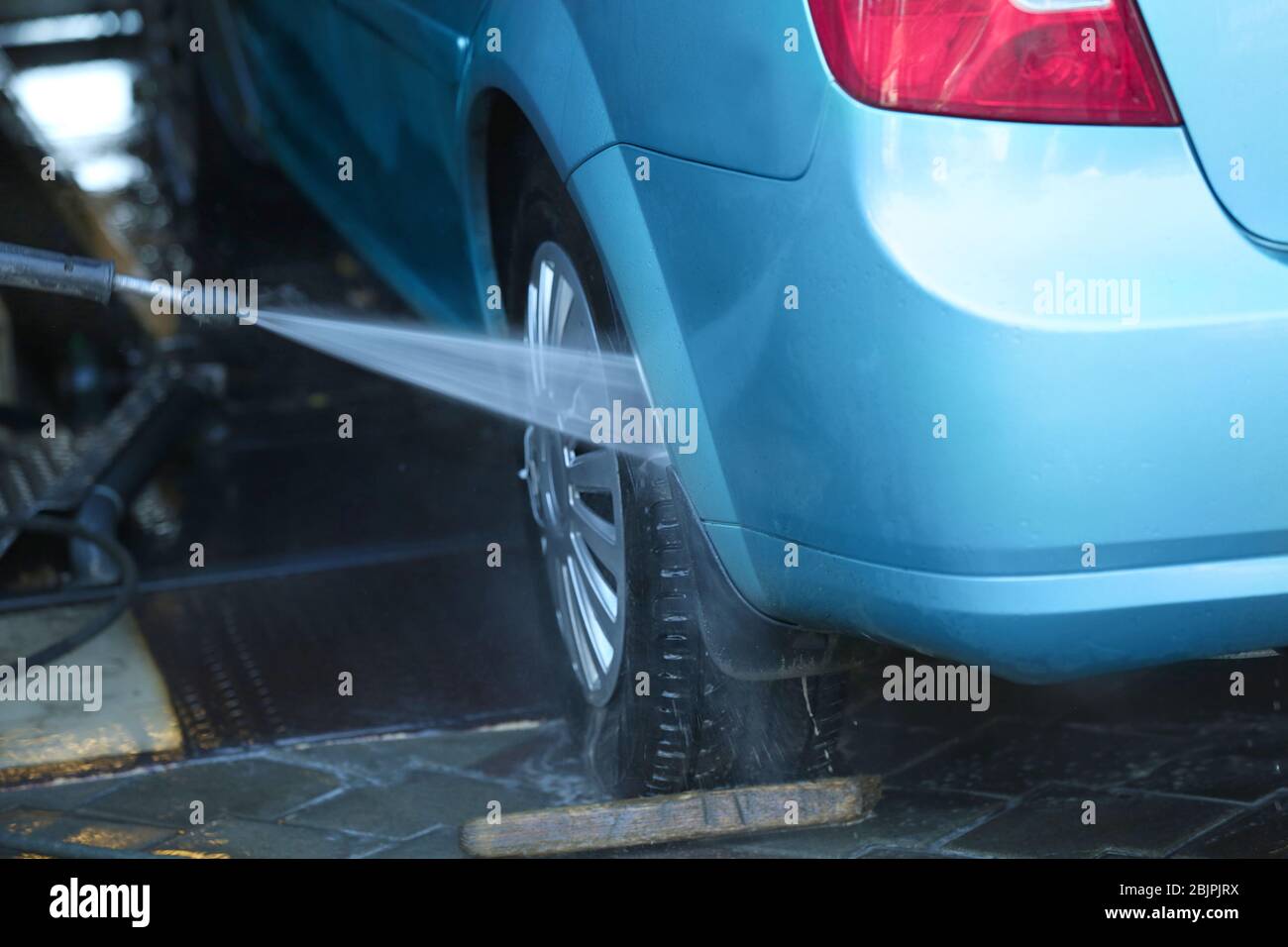 Cleaning automobile with high pressure water at car wash Stock Photo ...