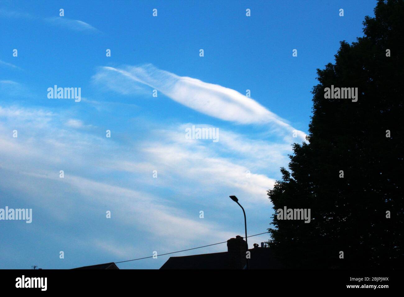 Pretty white clouds in a clear, blue sky in Manchester, England Stock ...