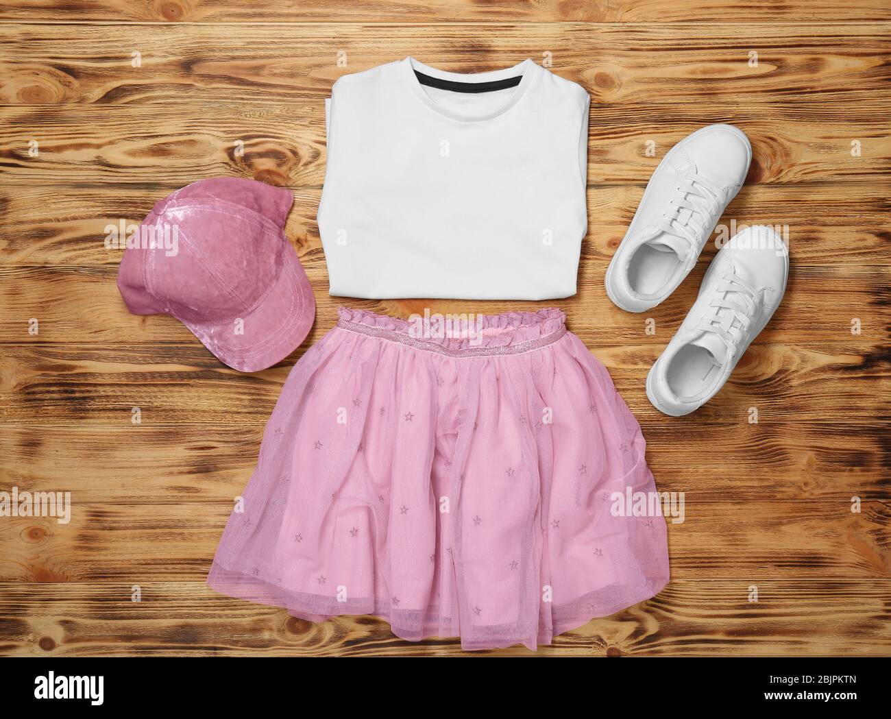 Set of child's clothes on wooden background Stock Photo - Alamy