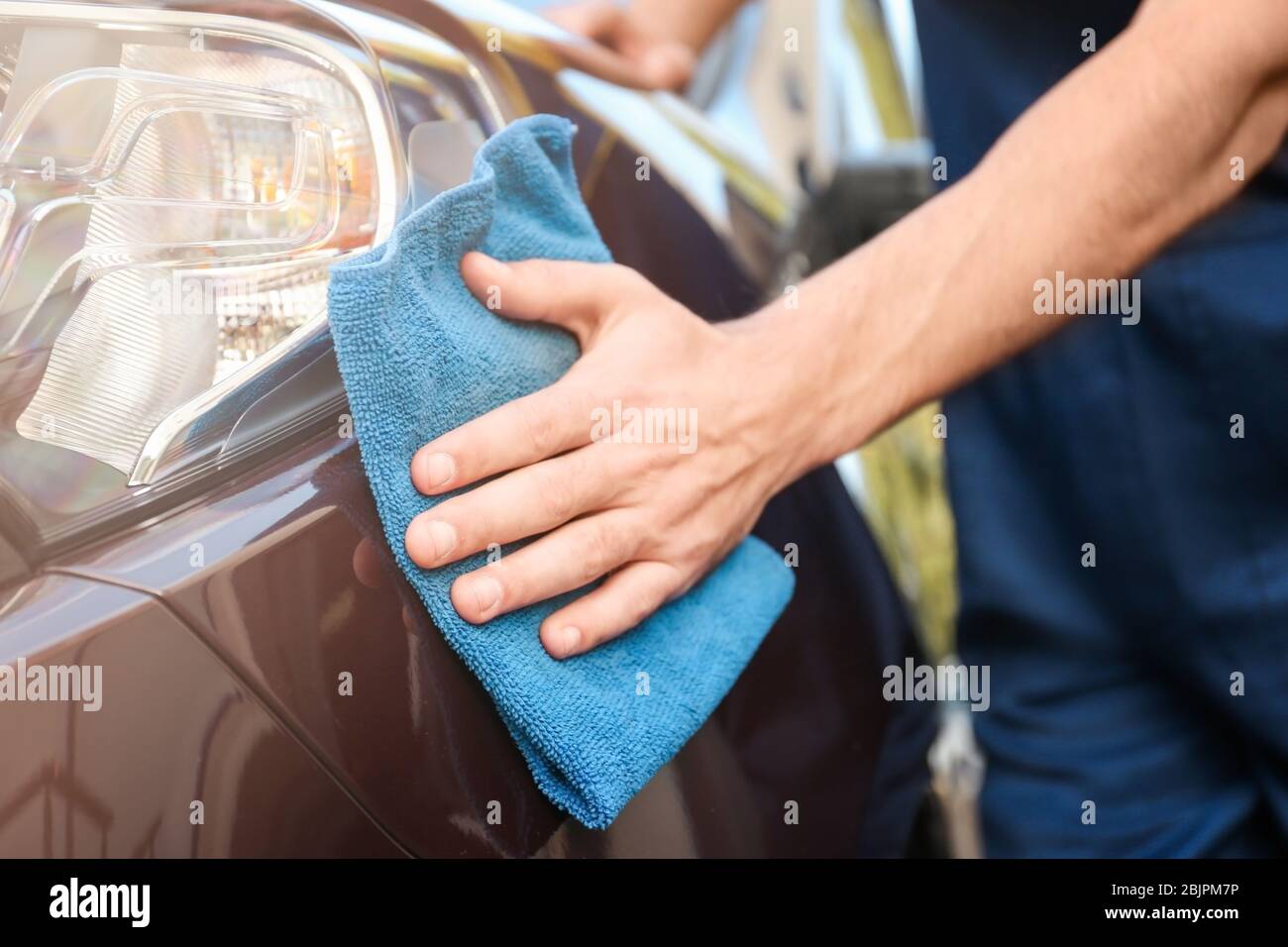 Man cleaning car with rag outdoors Stock Photo - Alamy