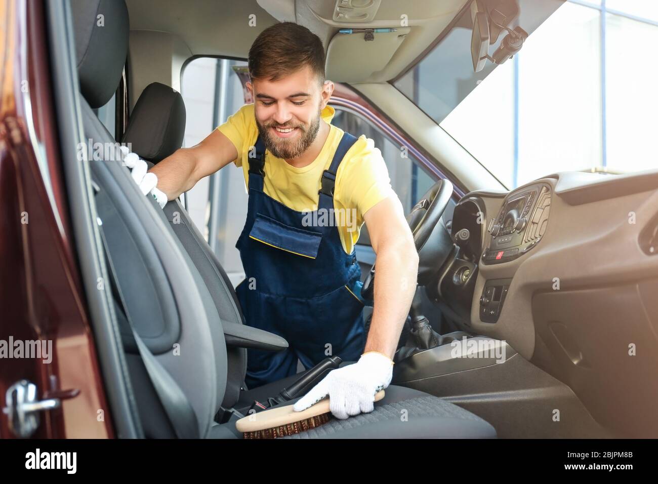 Man in uniform cleaning car hi-res stock photography and images - Alamy