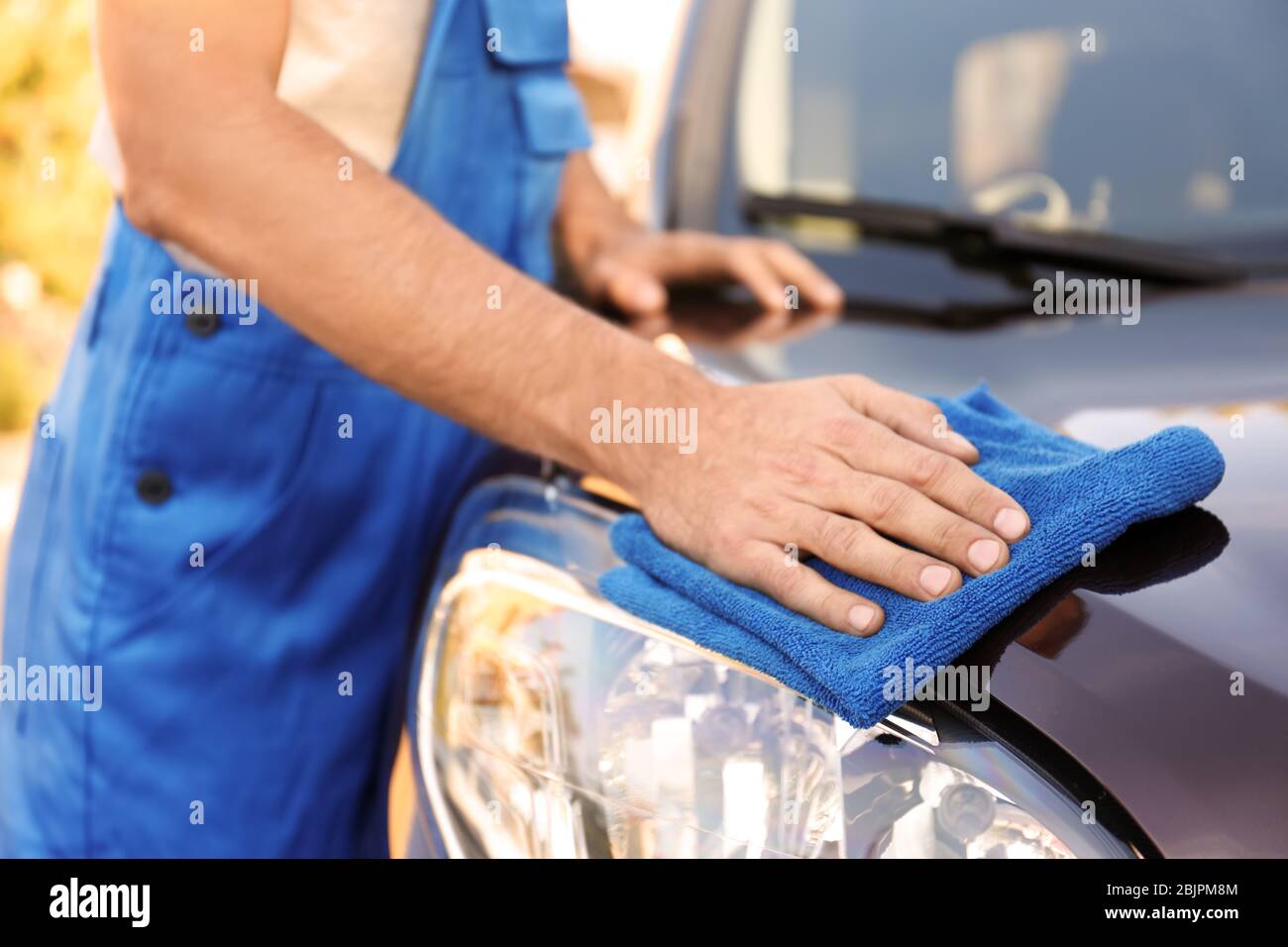 Man cleaning car with rag outdoors Stock Photo - Alamy