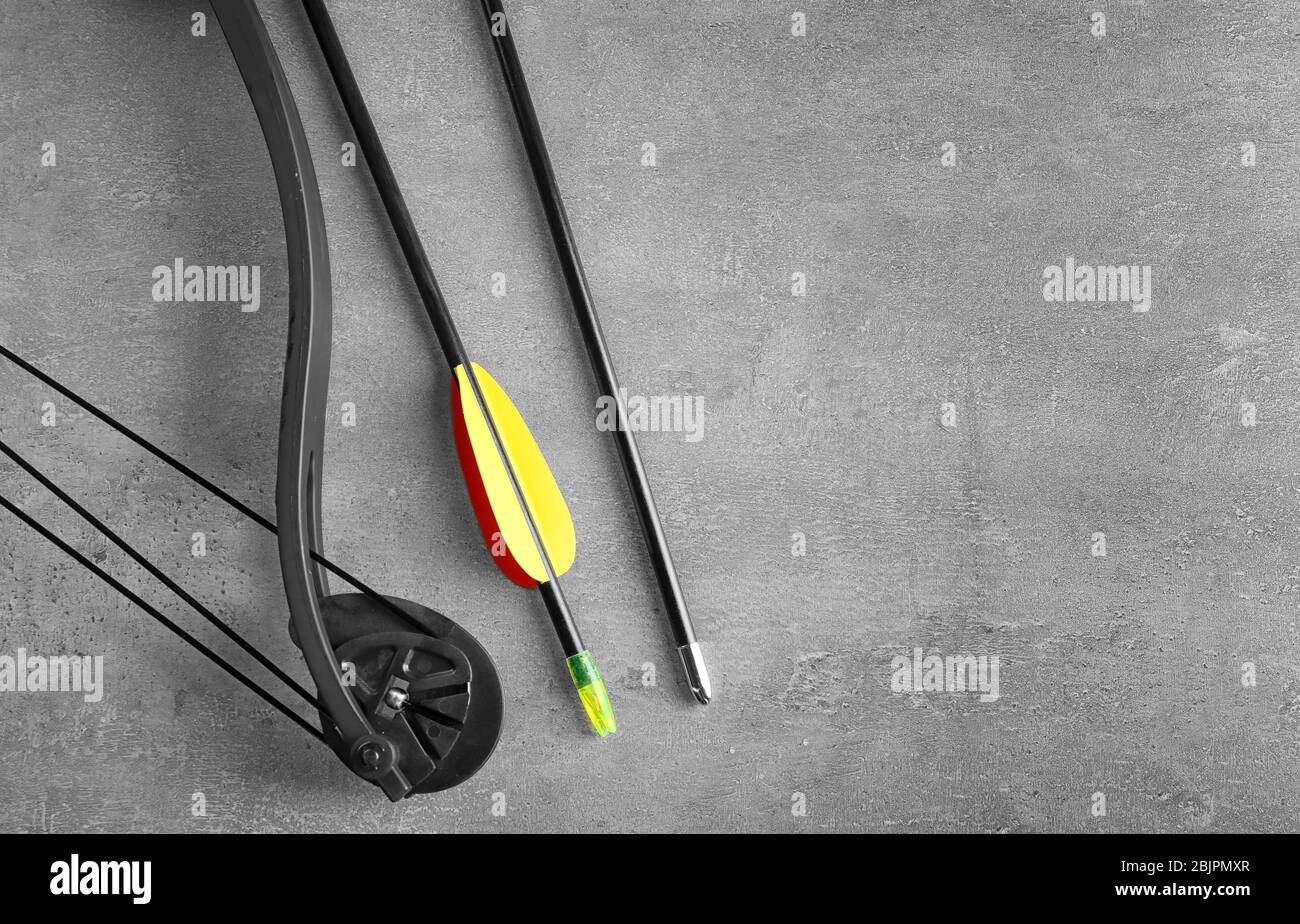 Bow with arrows on table Stock Photo - Alamy