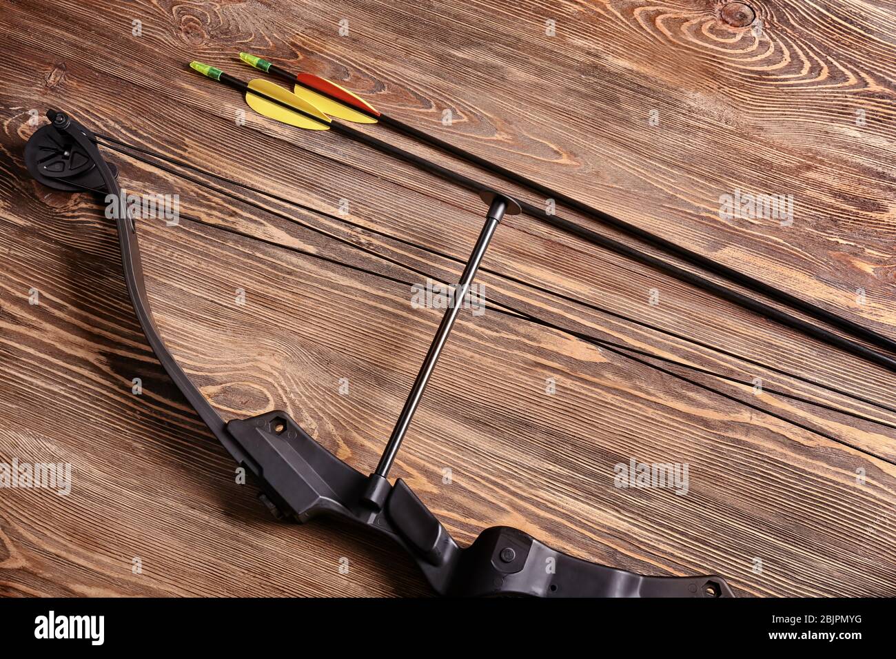 Bow with arrows on table Stock Photo - Alamy
