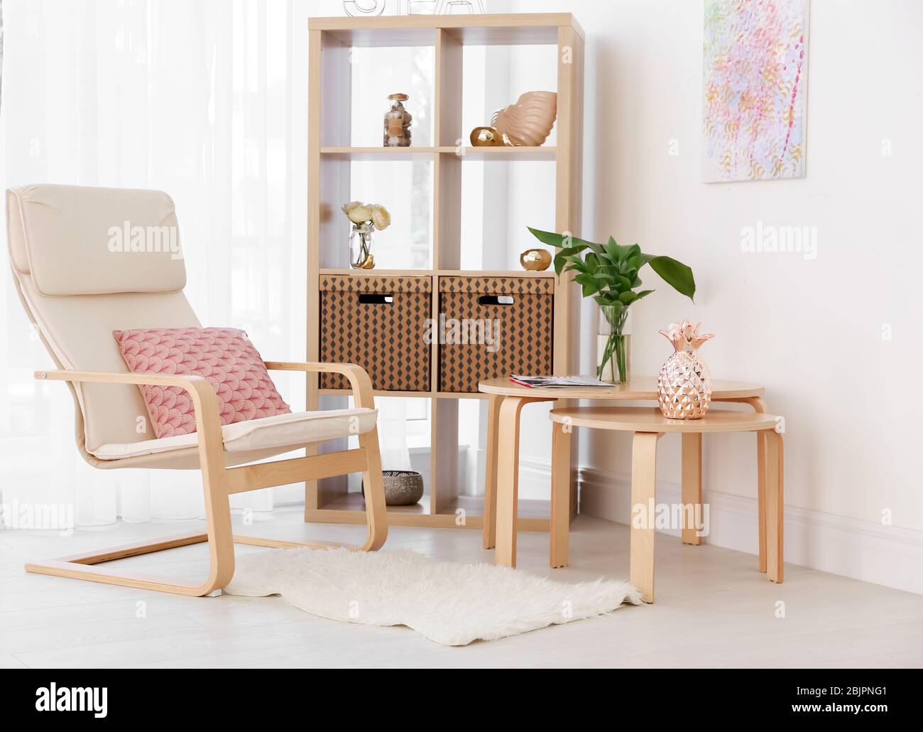 Room interior with armchair and shelving unit Stock Photo - Alamy