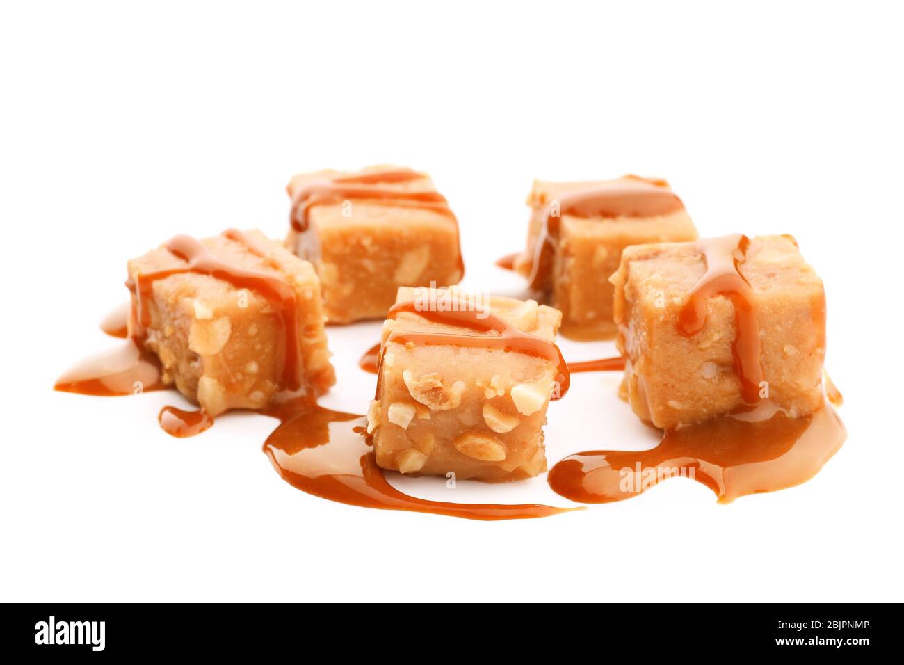 Delicious candies with caramel sauce on white background Stock Photo ...