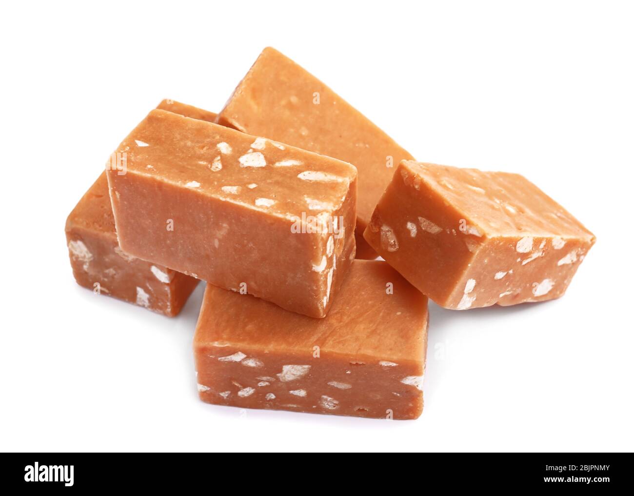 Delicious caramel candies on white background Stock Photo - Alamy
