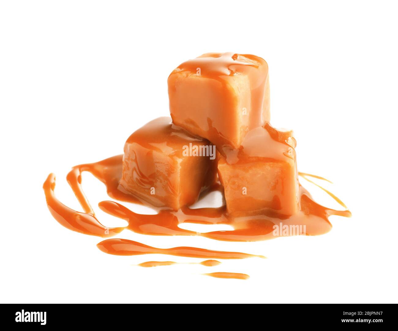 Delicious candies with caramel sauce on white background Stock Photo ...