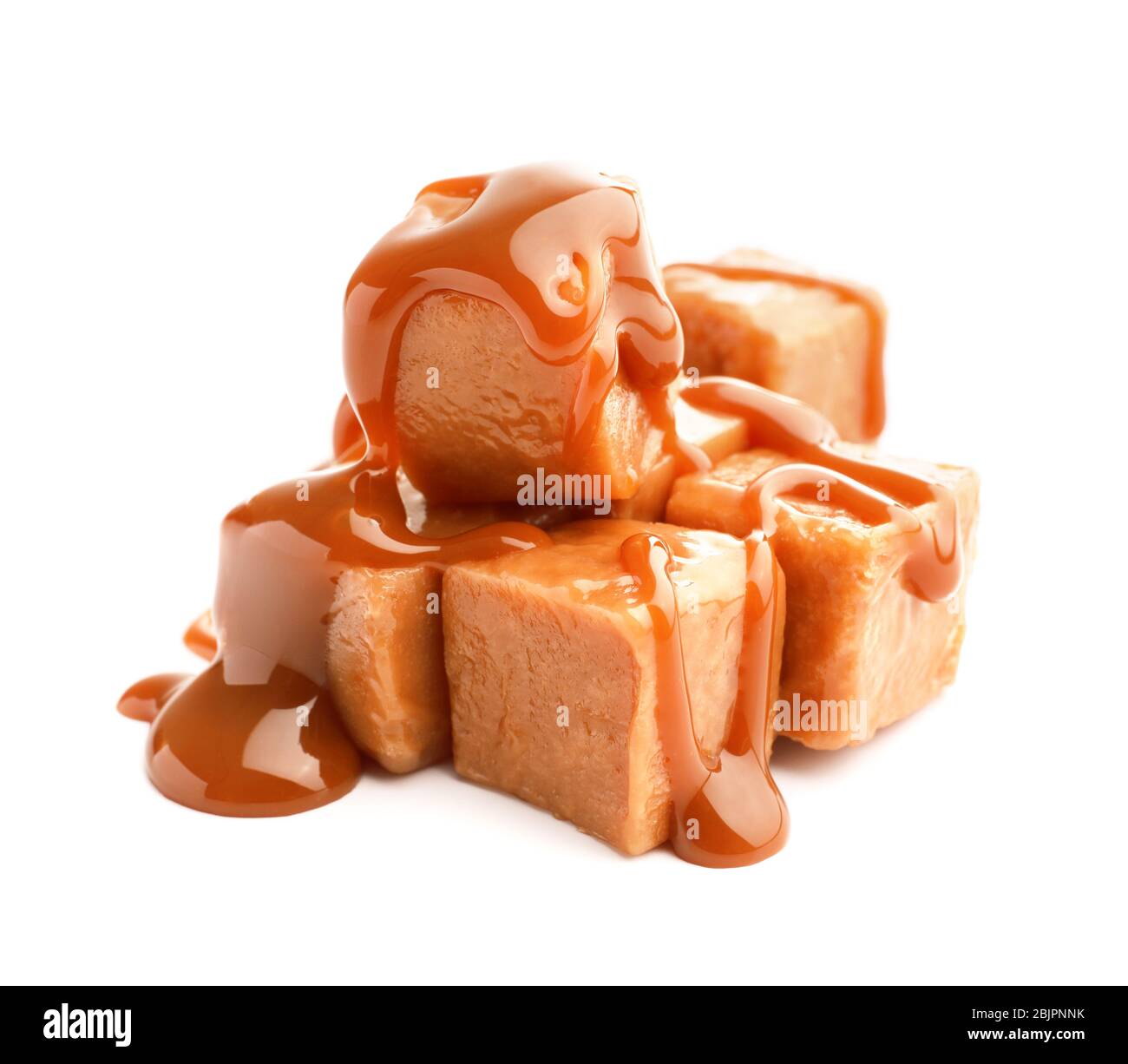 Delicious candies with caramel sauce on white background Stock Photo ...